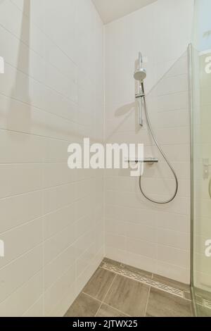 Glass partition between shower tap and wall hung toilet in modern ...