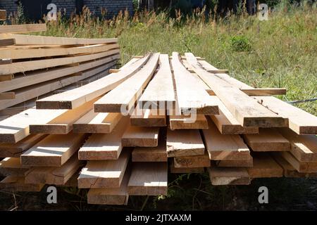 Folded finished boards at the sawmill close up Stock Photo - Alamy