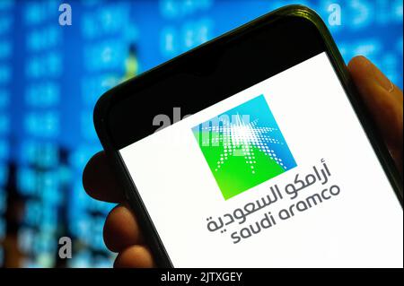In this photo illustration, the Saudi Aramco logo is displayed on a ...