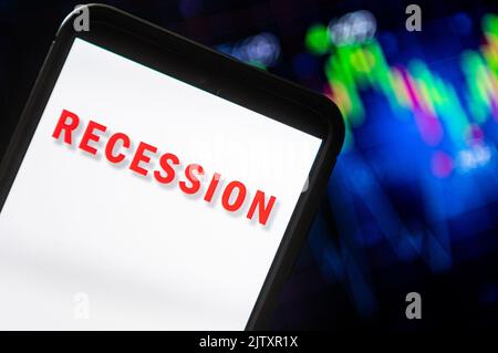 In this photo illustration a Recession logo seen displayed on a ...