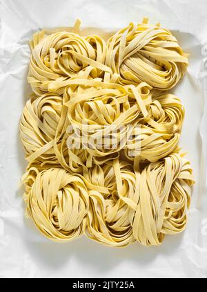 Raw tagliatelle fresh pasta ready to cook Stock Photo - Alamy