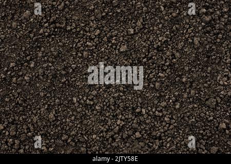Dark fertile soil texture close up with natural organic ground and ...
