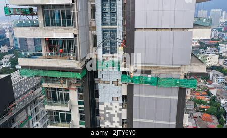 Suspended construction cradle on the background facade of the building ...