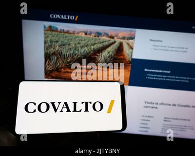 Person holding cellphone with webpage of Mexican banking company Banco ...