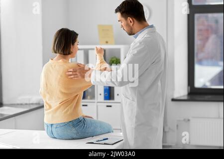 Young hispanic woman at physiotherapist appointment relaxed with ...