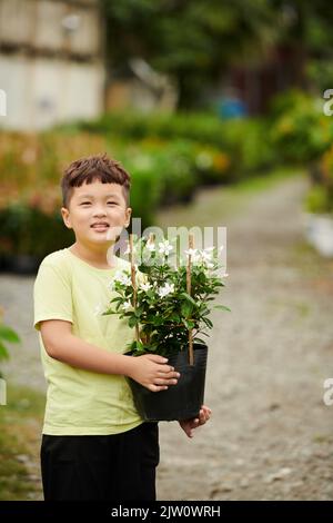 Smiling cheerful positive preteen boy looking for fresh delicious ...