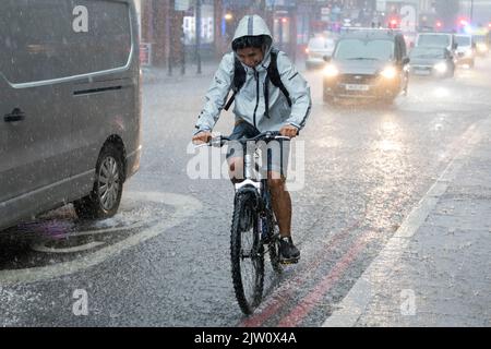 Amber rain catches Londoners this afternoon at Oxford Street. Image ...