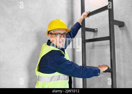 builder or worker in helmet climbing ladder Stock Photo - Alamy