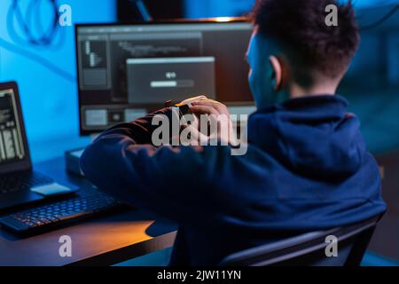 hacker with smart watch and computers in dark room Stock Photo - Alamy