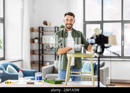 man or blogger showing old chair renovation Stock Photo - Alamy