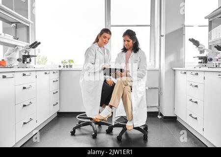 scientists with tablet pc working in laboratory Stock Photo - Alamy