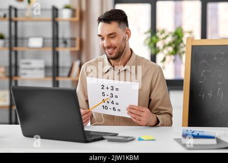 male math teacher having online class at home Stock Photo - Alamy