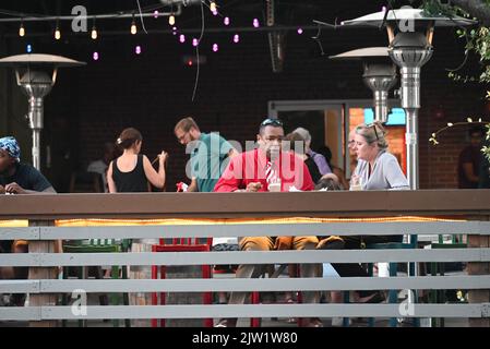 Customers on the outdoor patio at the Morgan Street Food Hall in ...