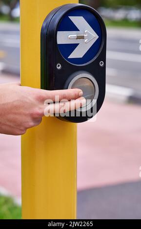 Hand pressing button to cross the road Stock Photo - Alamy