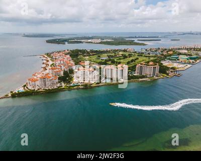 Breathtaking drone view of boat floating in sea near contemporary ...