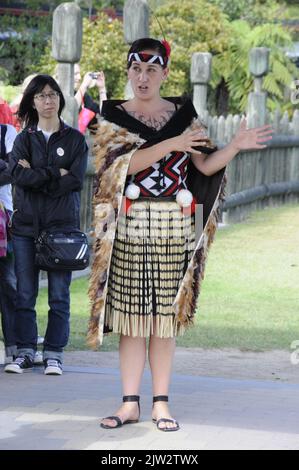 A Maori woman give an introduction talk about Maori culture to a group ...