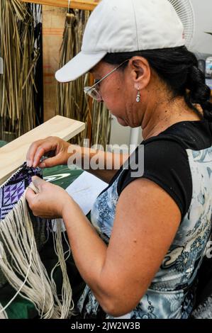 Hand-weaving Maori clothes using materials from the land at Te Puia ...