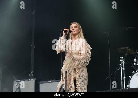 Lyra - singing to the connect audience wearing a lace thrilled blouse ...