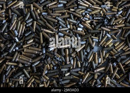 Bullet casings pile in weapon production plant storage Stock Photo - Alamy