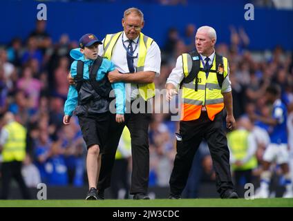Stewards remove a pitch invader as Liverpool play Salzburg in the UEFA ...
