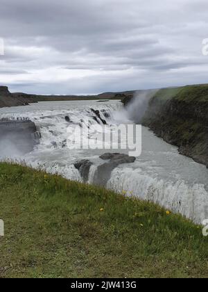 A vertical shot of the Gullfoss waterfall in Iceland on a sunny day ...