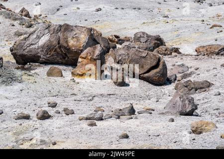 volcanic bombs among the tephra in a fumarole field on the slope of a ...