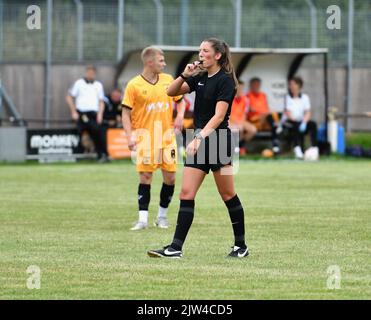 A female referee officiating at the semi-professional football match ...