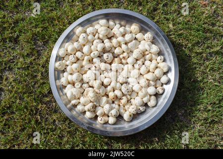 Makhana also known as Puffed Lotus seeds or Fox nuts in plate. Indian ...