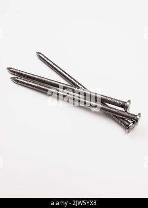 Three nails on a white background Stock Photo - Alamy