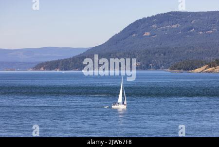 Sailboat in Canadian Landscape by the ocean and mountains Stock Photo ...