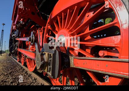 Red frame and wheels of a steam locomotive with cranks, rods and axles ...