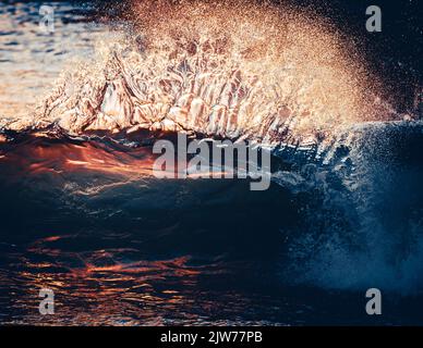 Crisp Cornish waves rising up from the reef of Porthleven at sun set ...