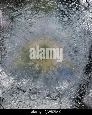 Bulletproof glass after test. bulletproof glass with cracks and a ...