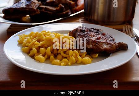a Swabian meal of spaetzle or spaetzli with fried spareribs, Munich ...