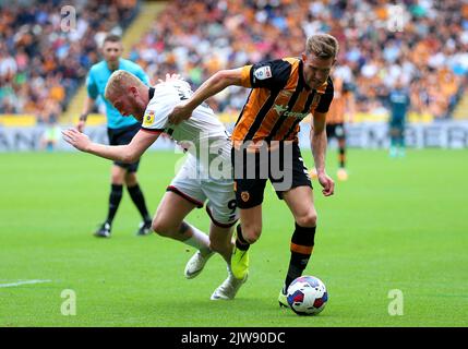 Hull City's Oliver McBurnie (left) and Coventry City's Liam Kitching ...