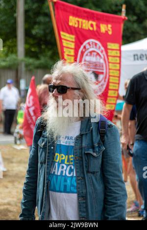 Caucasian man with long beard at political campaign election holding ...