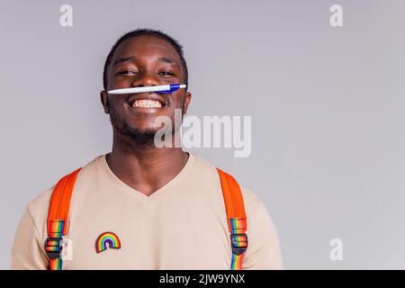 Smiling man studying, holding notebooks and looking happy, standing ...
