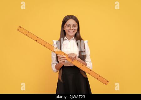smiling tween girl hold ruler. back to school. algebra and geometry ...
