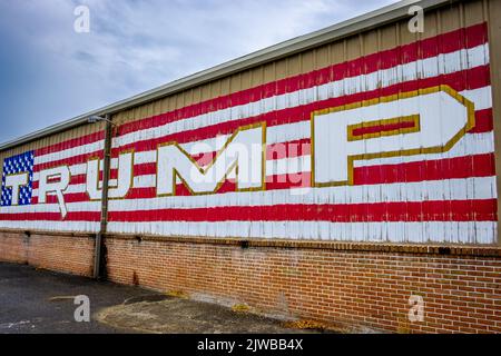 A large Donald Trump sign painted on the side of a building near ...