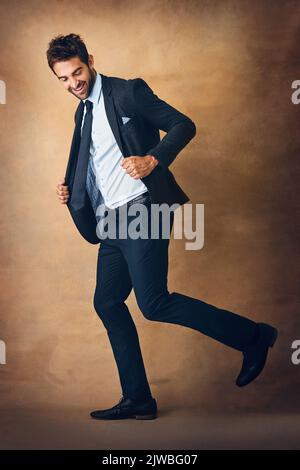 Studio shot of businessman against brown background Stock Photo - Alamy