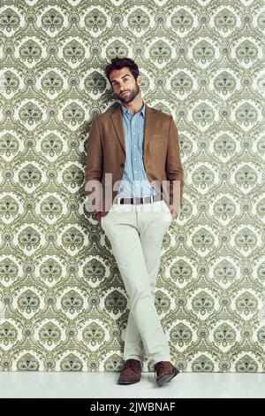 On that style grind. Studio shot a handsome and stylishly dressed young ...