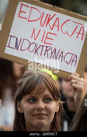 A student holds a sign with the words 'Czarnek is the pineapple of ...