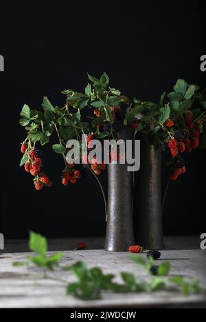 Closeup of ripe dark mulberries in brushed gold bowl. Soft natural ...