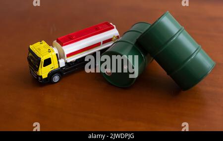 small toy combine with toy oil barrel Stock Photo - Alamy