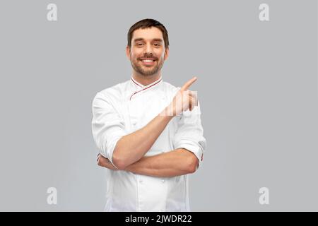 happy smiling male chef pointing to something Stock Photo - Alamy