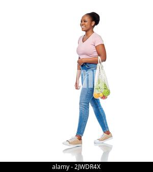 african woman with food in reusable string bag Stock Photo - Alamy