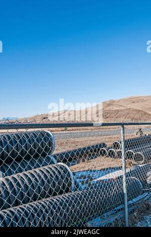 Flexible conduit or culvert pipes stacked up in an active landfill or ...