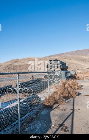 Flexible conduit or culvert pipes stacked up in an active landfill or ...