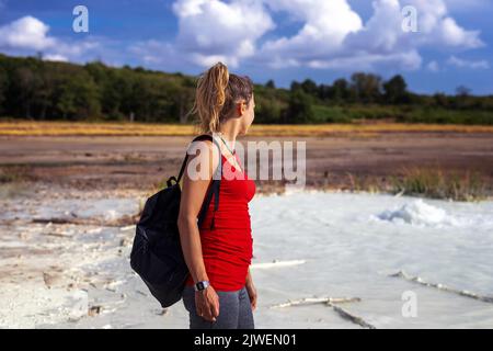 Hiker visits the caldera, a small circular crater with a marsh of ...