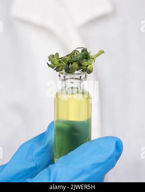 Oil cannabidiol CBD with bud marijuana on wood background Stock Photo ...